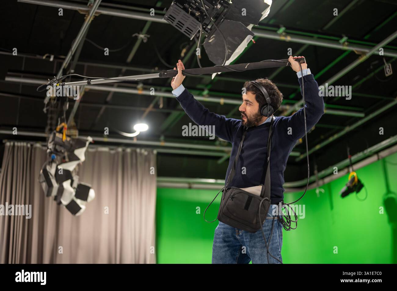 Boom microphone operator testing sound at TV studio. High quality ...