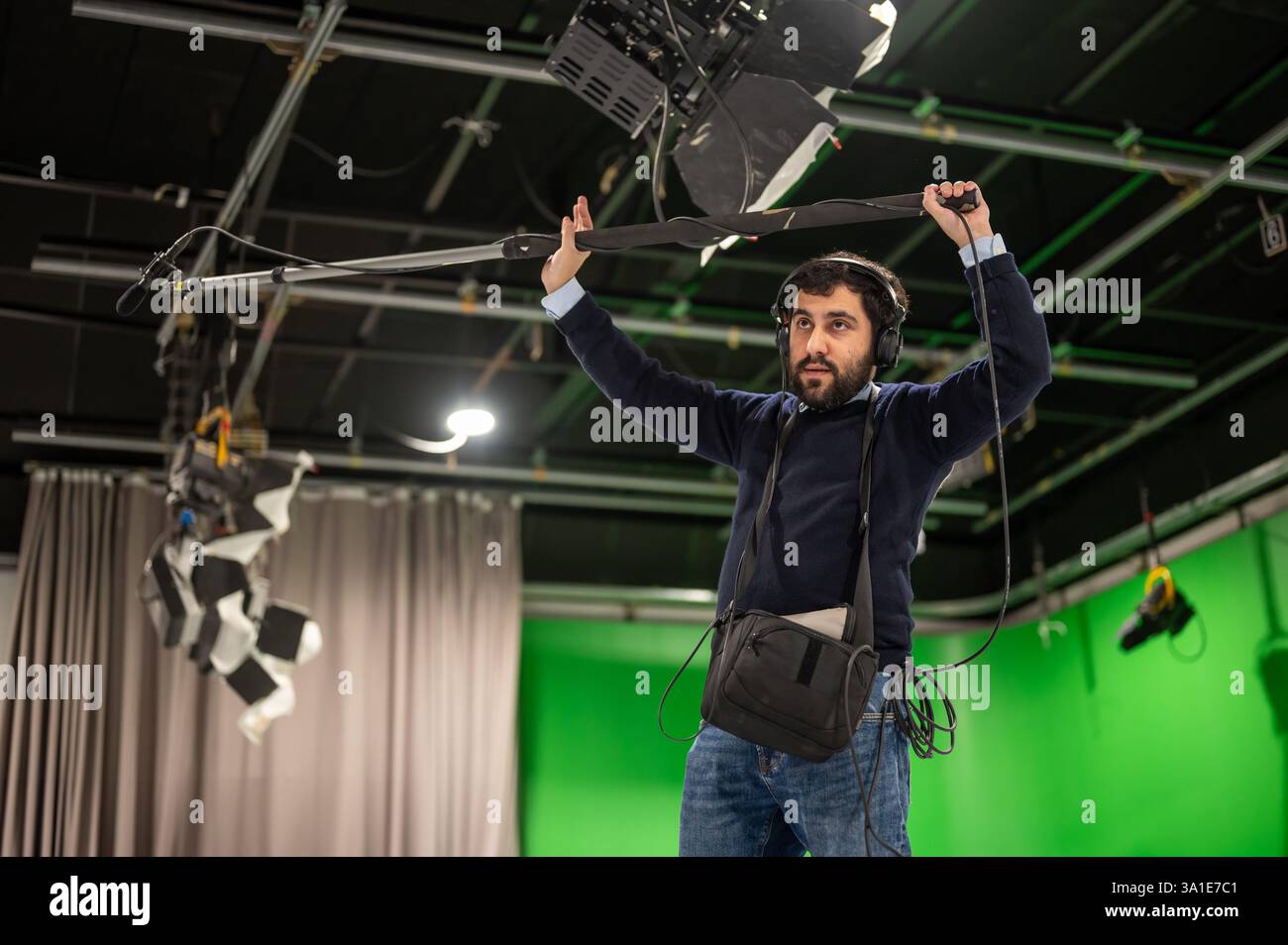 Boom microphone operator testing sound at TV studio. High quality ...