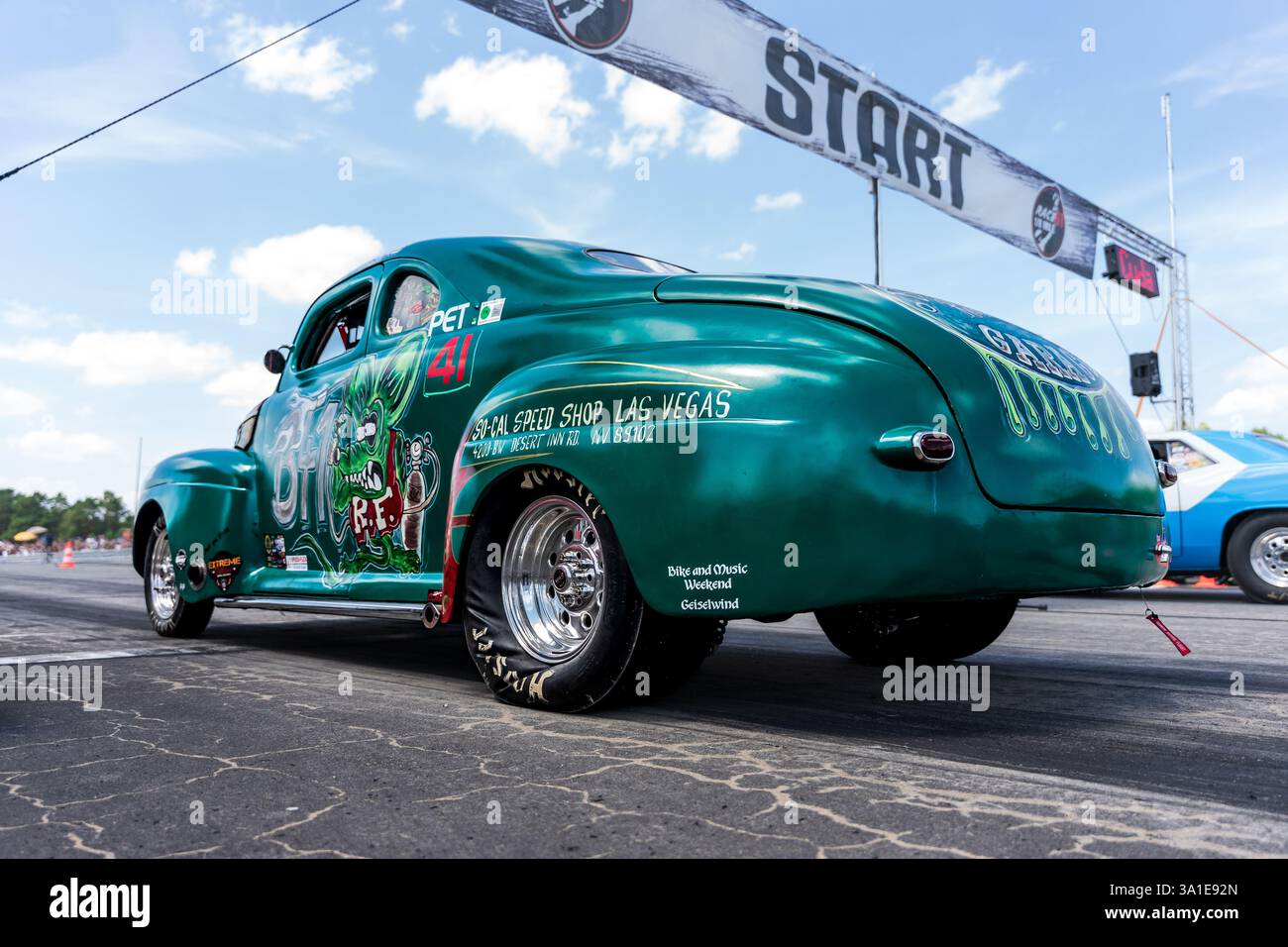 A custom retro car Ford Super Deluxe (1941) on the starting line. Rear ...