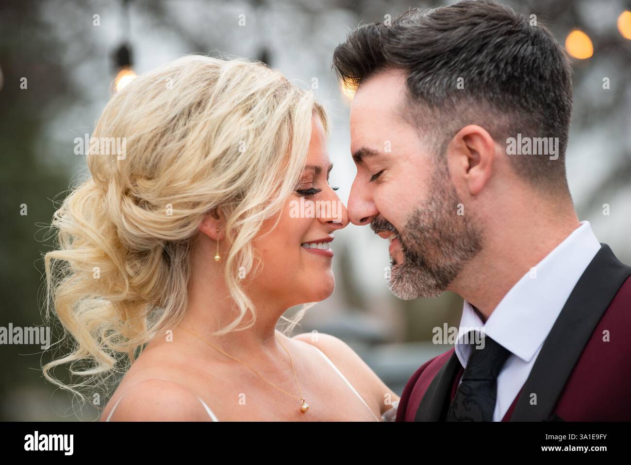 Bride and groom share a tender kiss on their wedding day, close-up ...