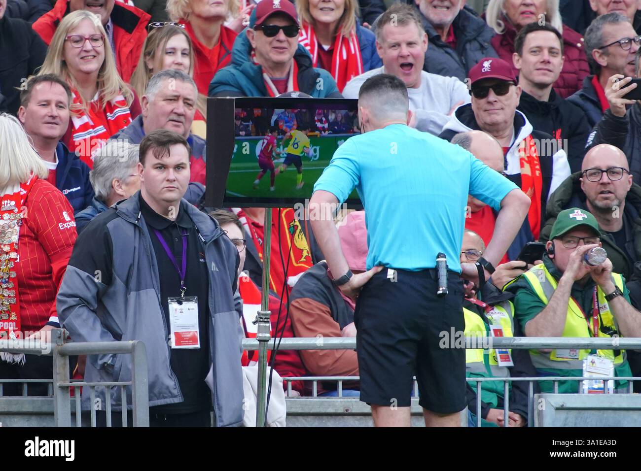 Referee Lewis Smith consults the pitch-side VAR before awarding a ...