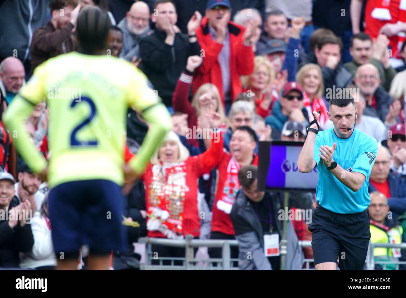Referee Lewis Smith (right) consults the pitch-side VAR before awarding ...
