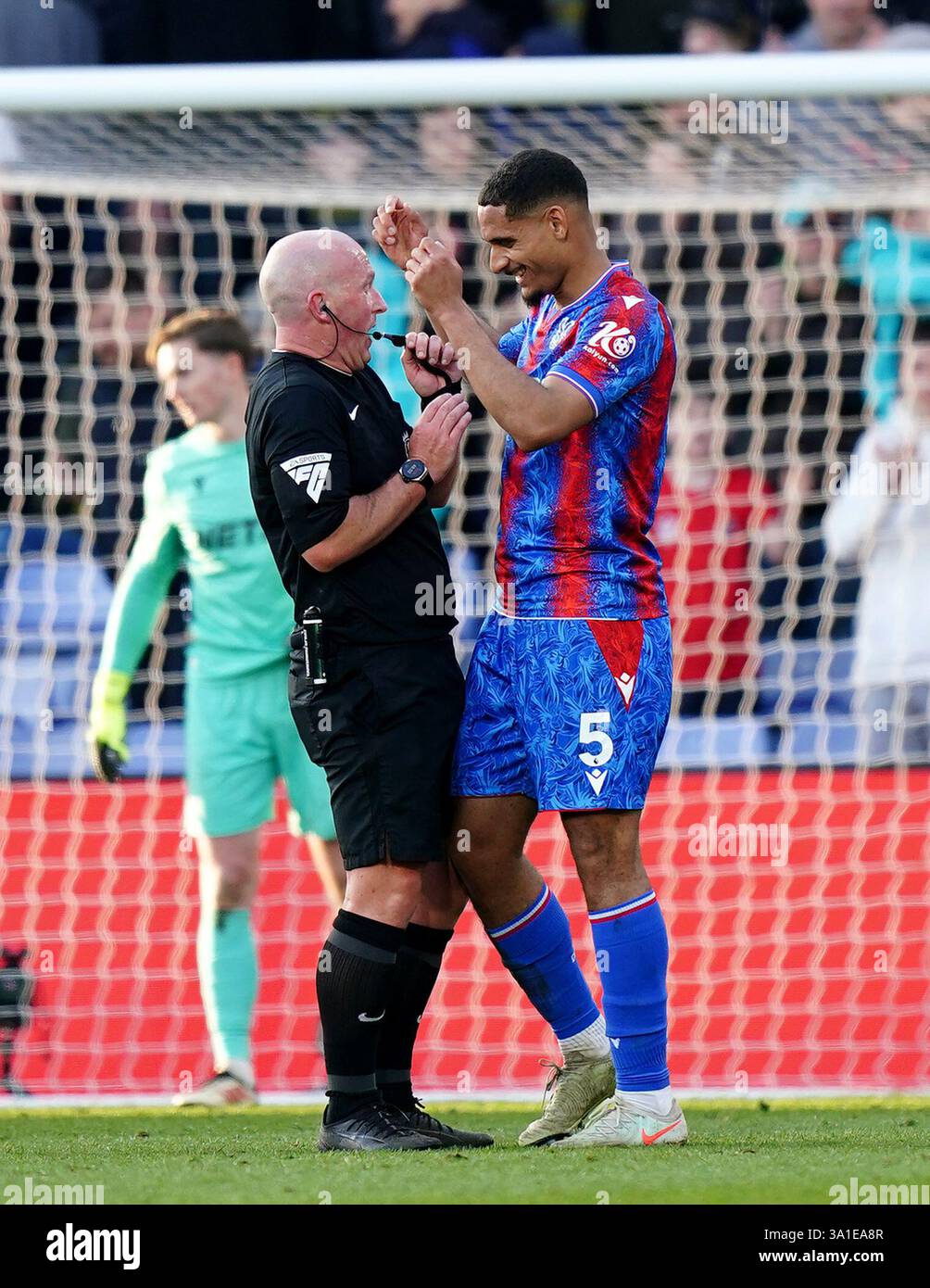 Crystal Palace's Maxence Lacroix jokes with referee Simon Hooper as he ...