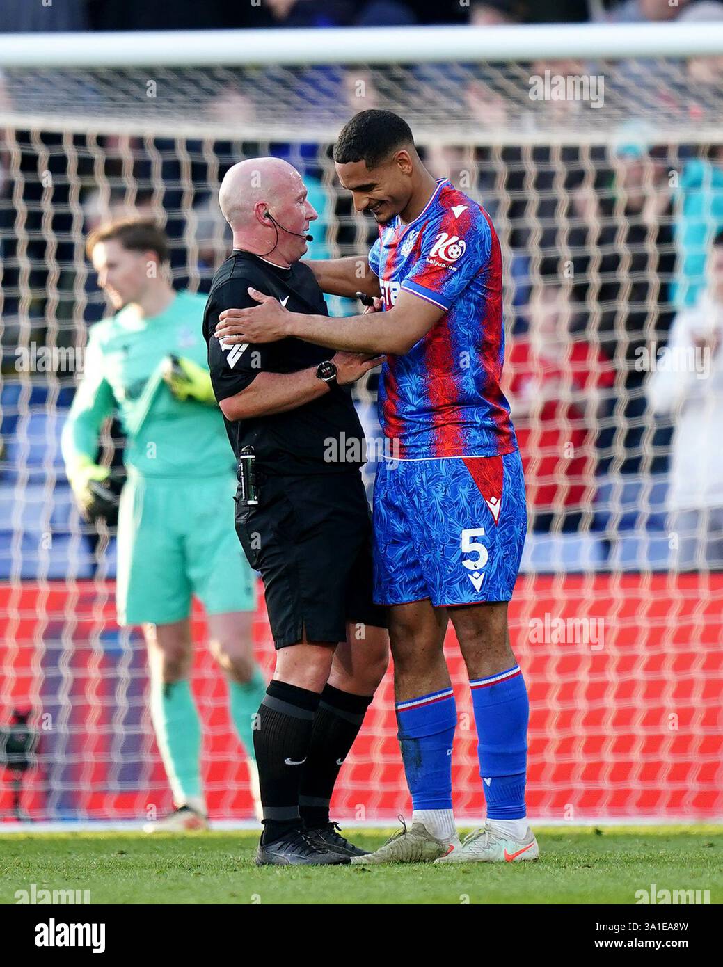 Crystal Palace's Maxence Lacroix jokes with referee Simon Hooper as he ...