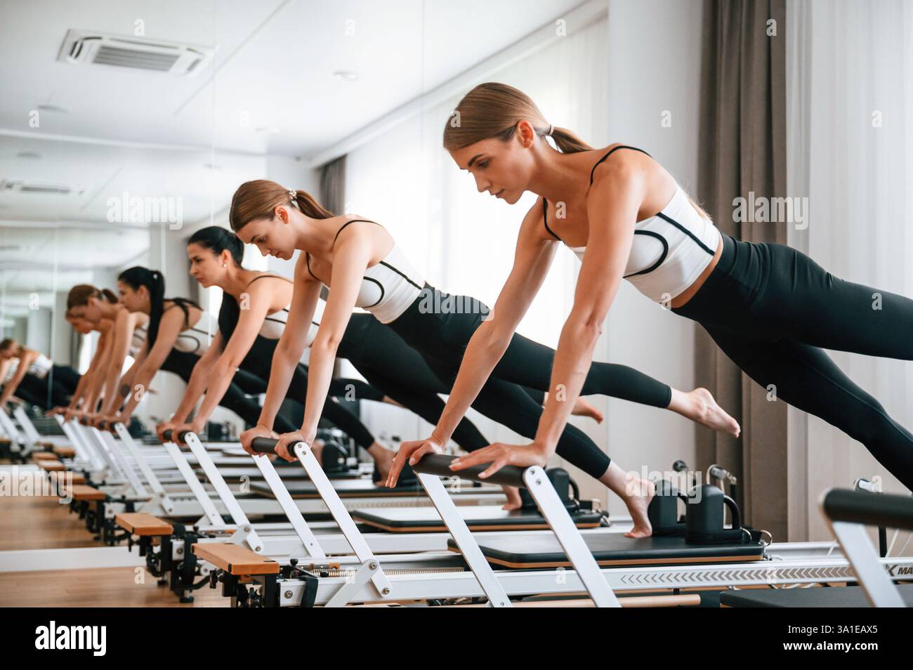 Doing push ups on the special device. Women in fitness center are doing ...