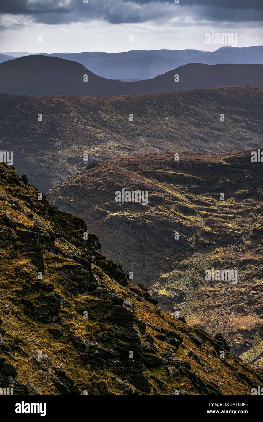 Majestic mountains create a dramatic backdrop of rolling hills and ...
