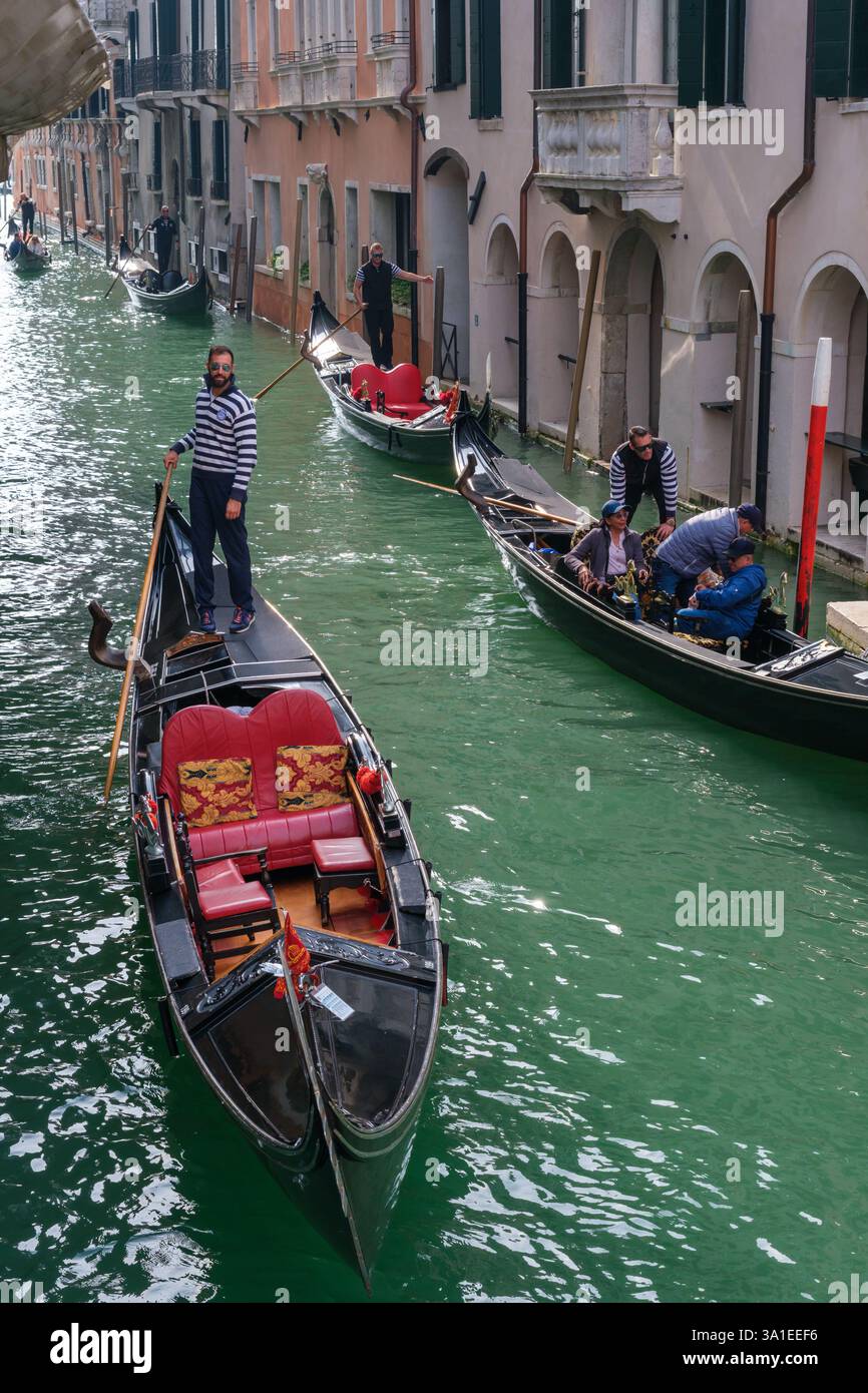 Venice, Italy - 12 October 2024: A gondolier in a striped uniform ...
