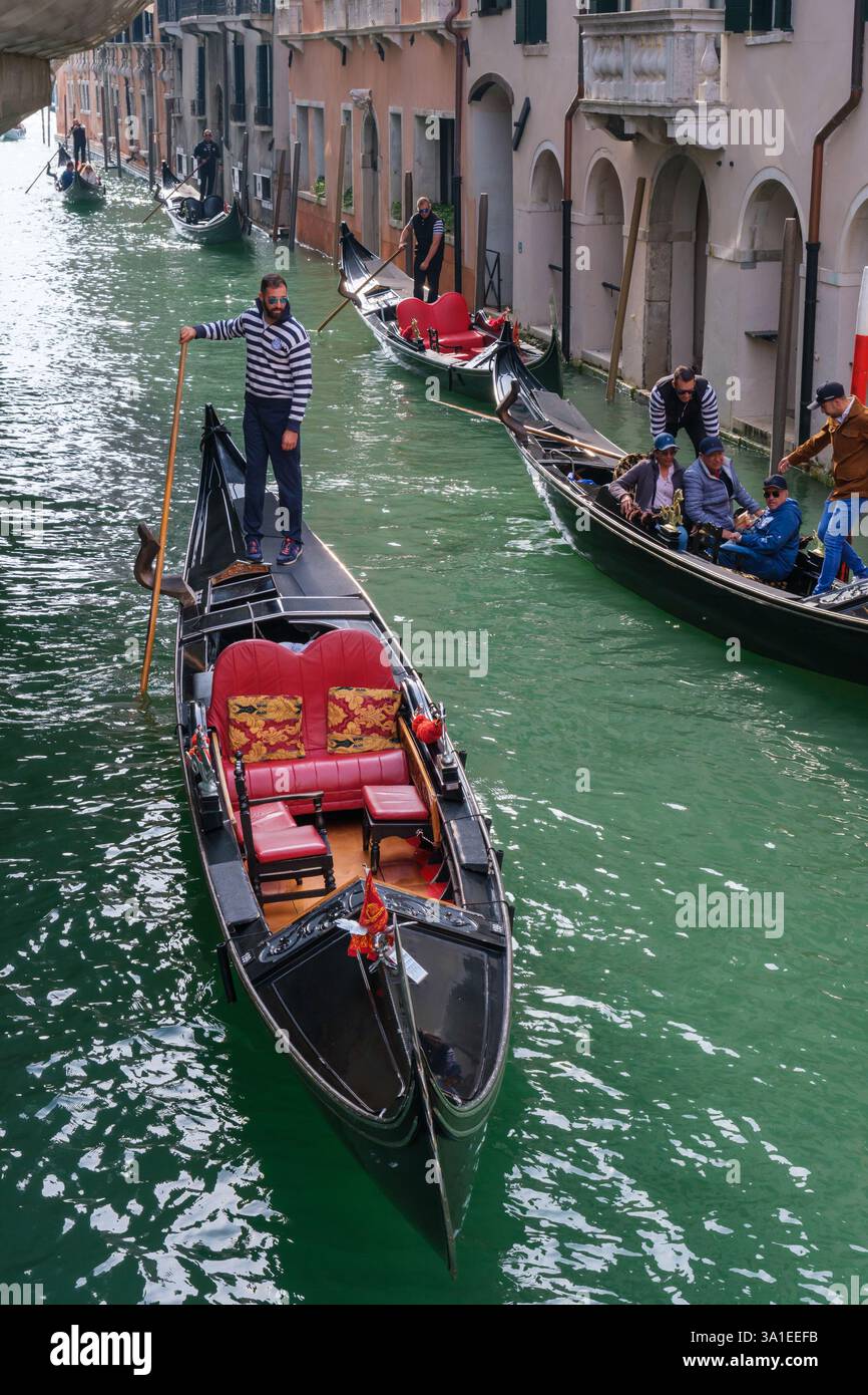 Venice, Italy - 12 October 2024: A gondolier in a striped uniform ...
