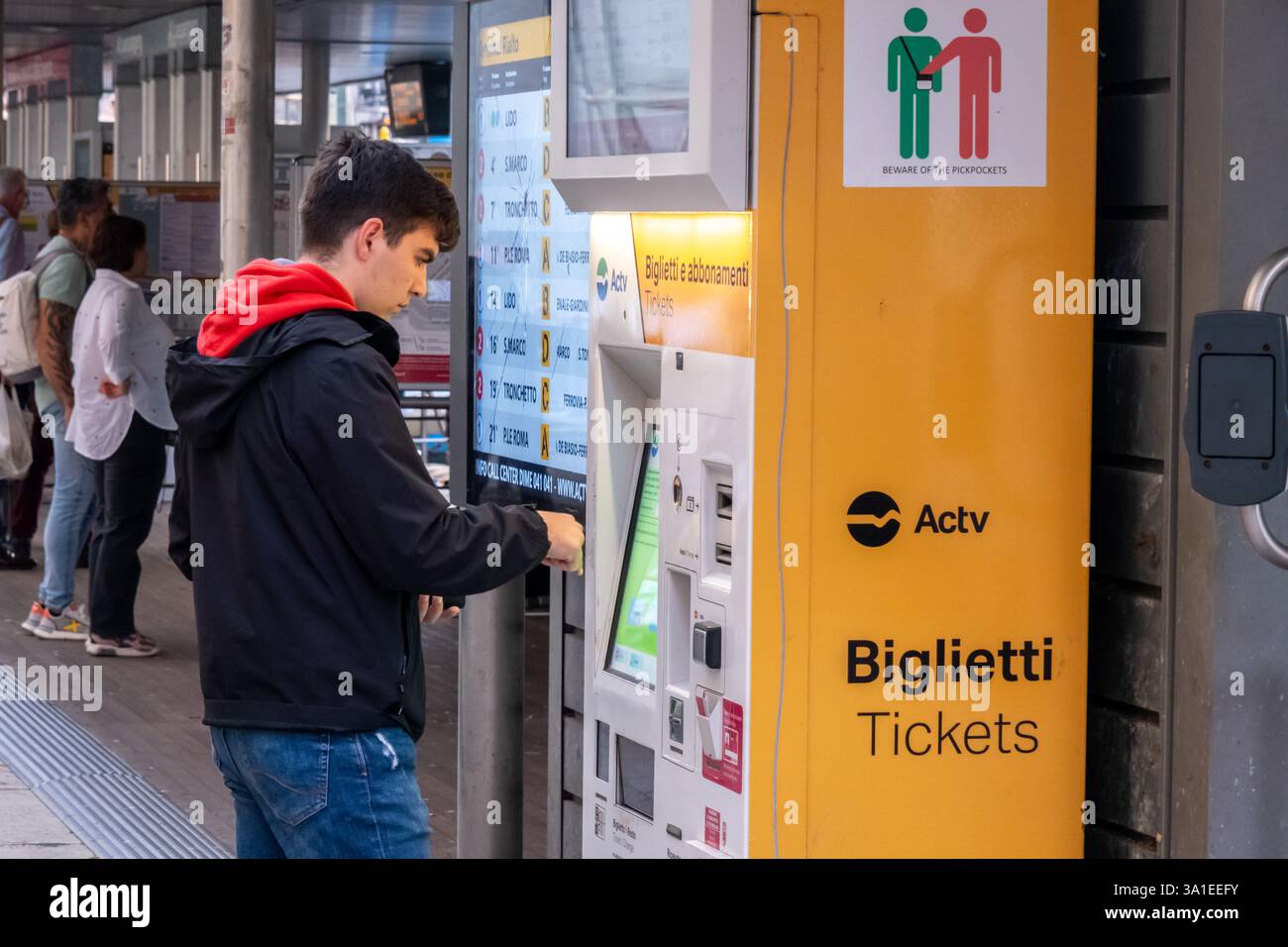 Venice, Italy - 12 October 2024: A man purchasing a vaporetto ticket at ...