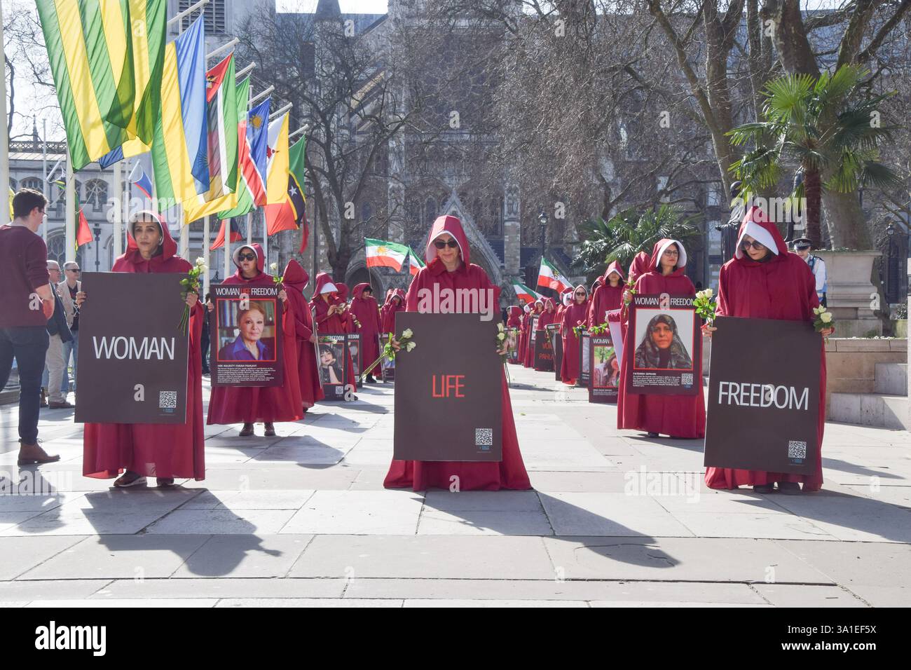 London, UK. 08th Mar, 2025. Women wearing 'The Handmaid's Tale ...