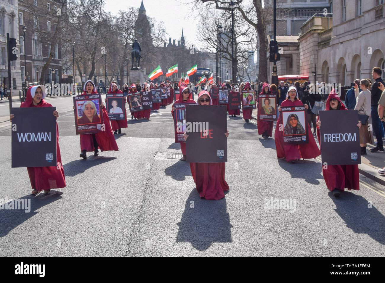 London, UK. 08th Mar, 2025. Women wearing 'The Handmaid's Tale ...