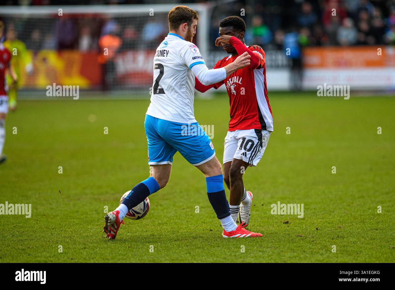 Ryan Cooney of Crewe Alexandra FC tackles Kelly Nmai of Salford City FC ...