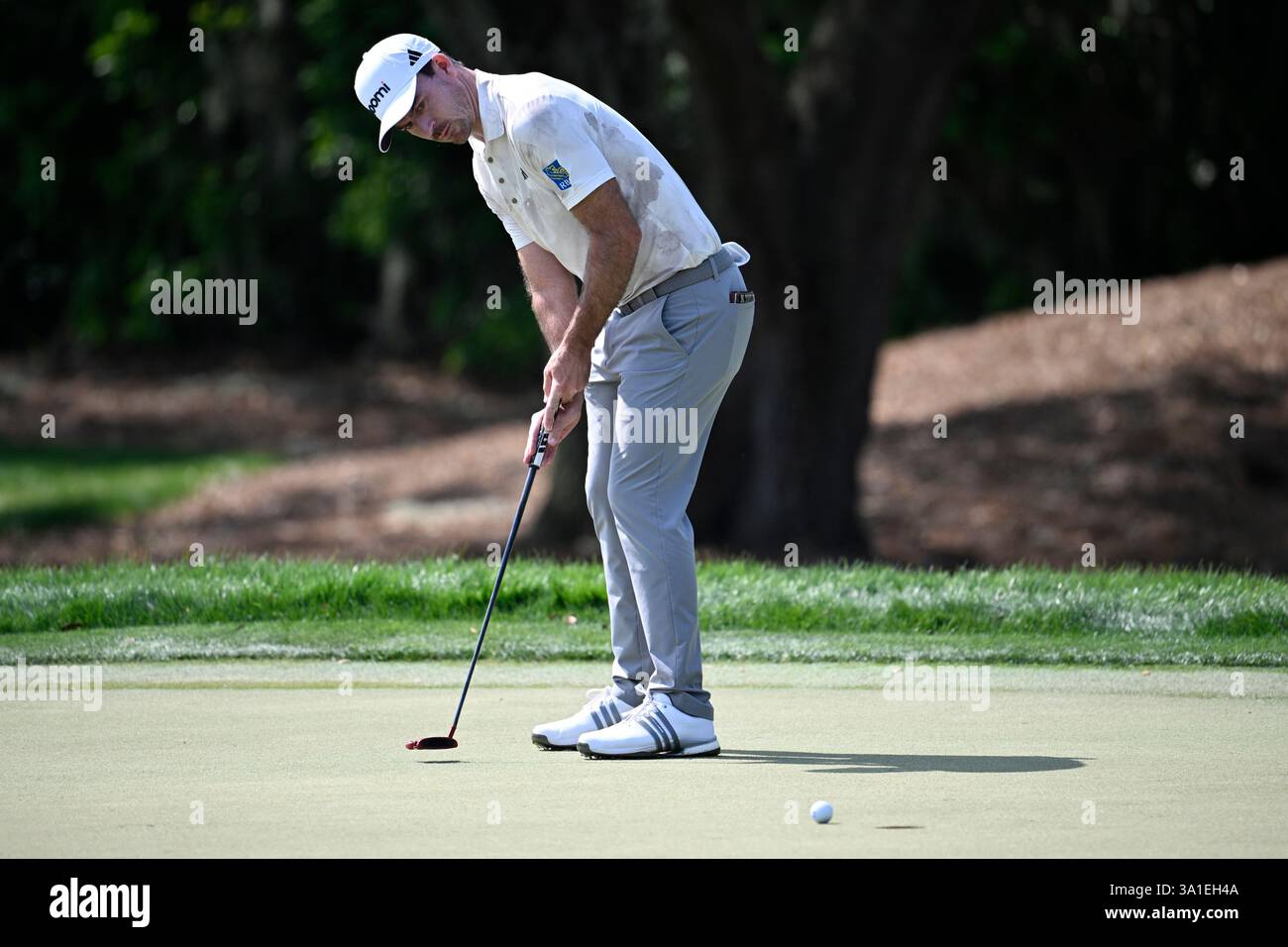 Nick Taylor, of Canada, watches his putt on the first green during the ...