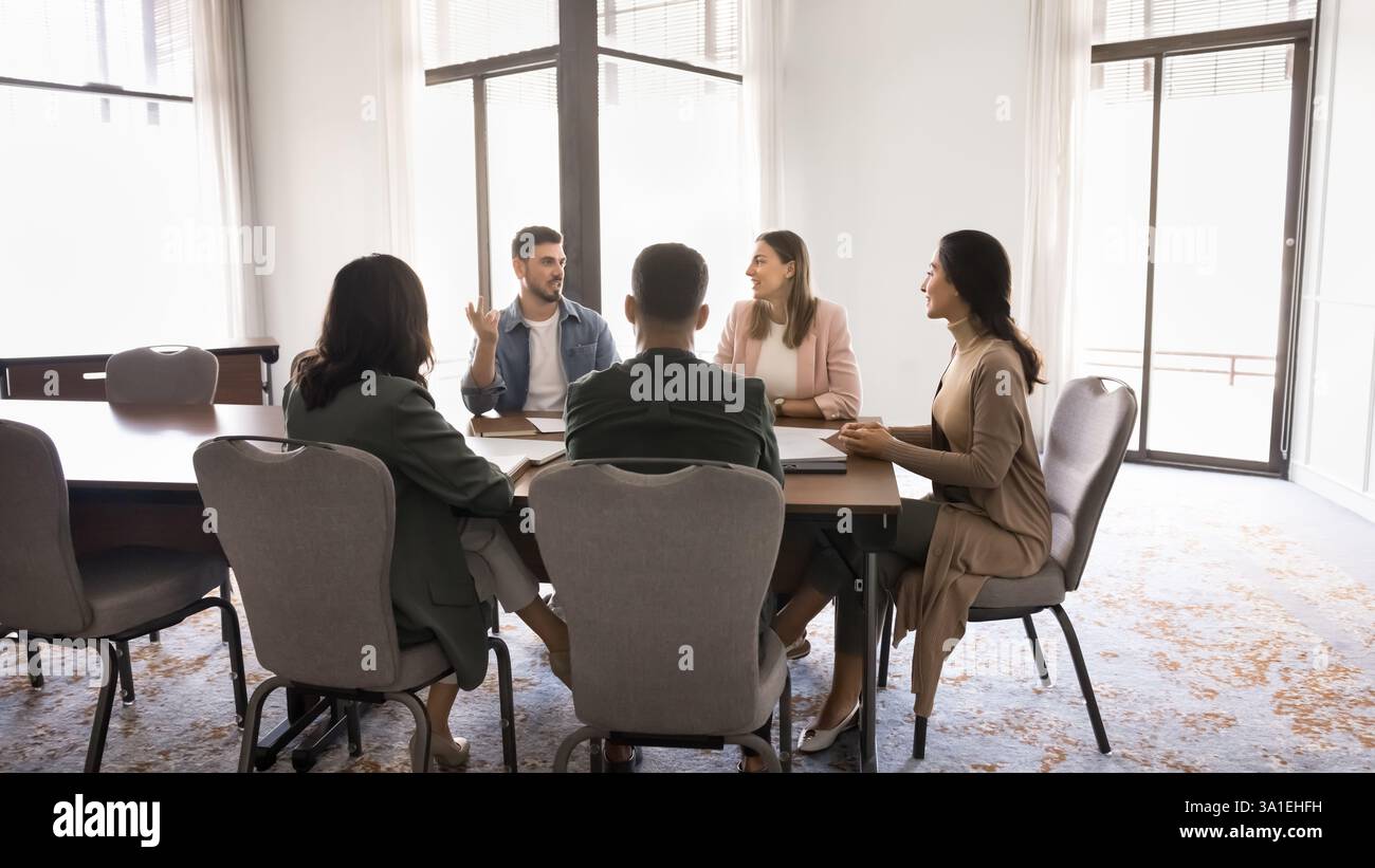 Professionals solve work-related matters sitting around conference ...