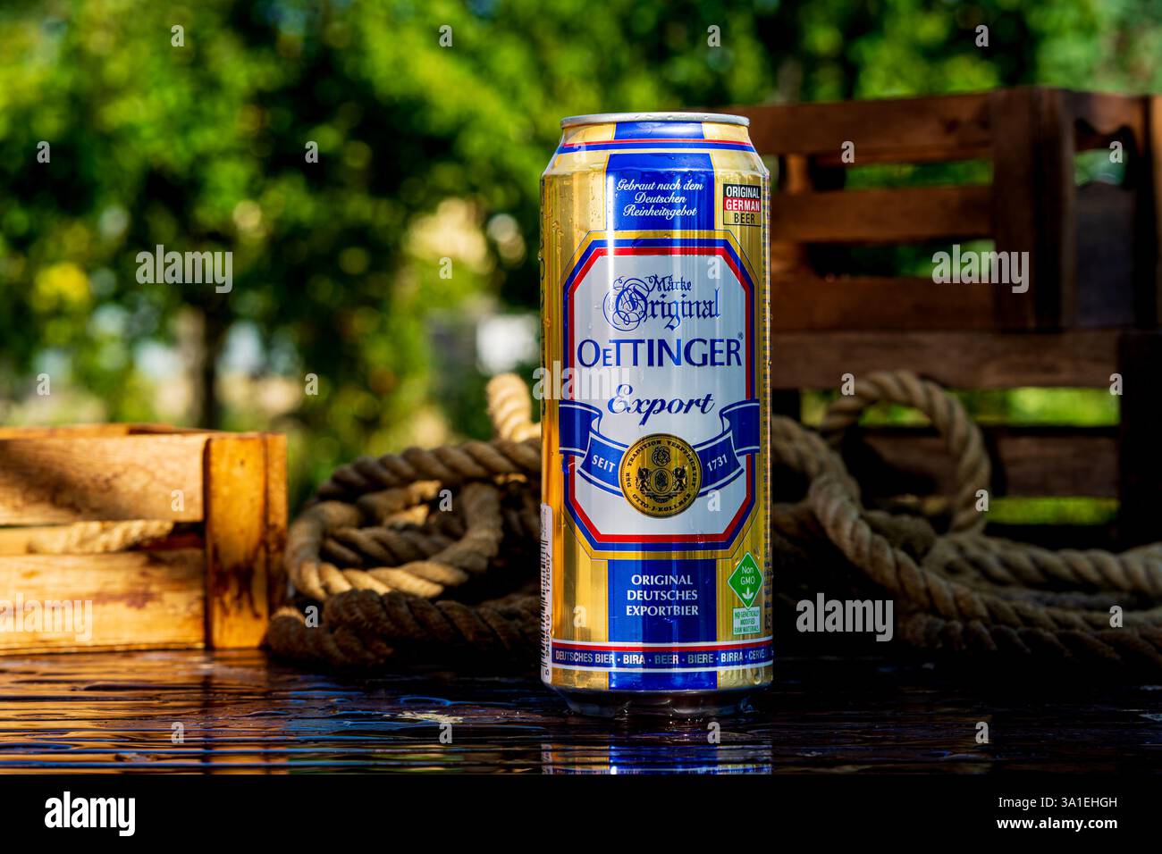 Oettinger beer can - condensation water droplets, outdoors background ...