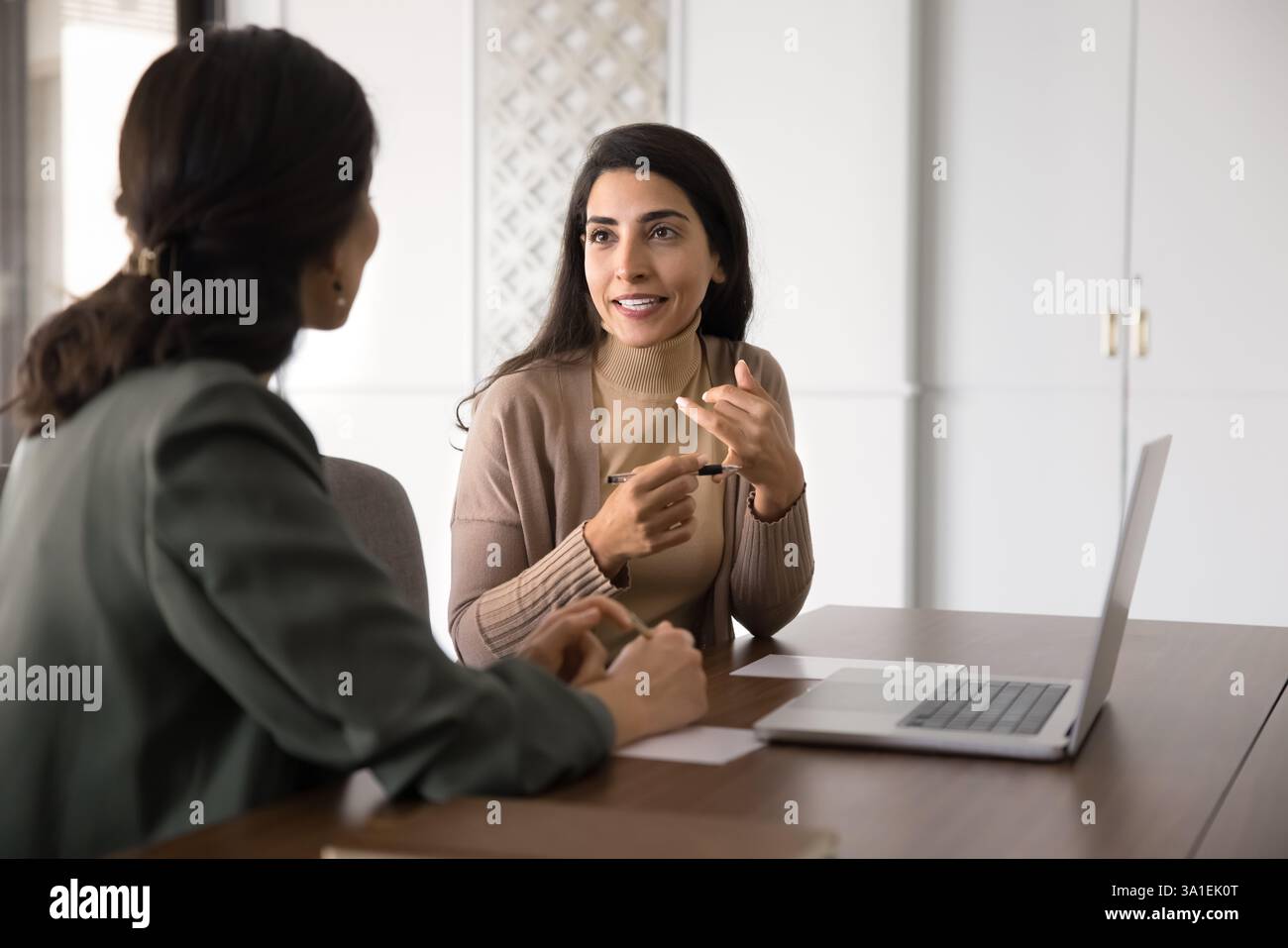 Colleagues discussing joint task, engaged in teamwork Stock Photo - Alamy