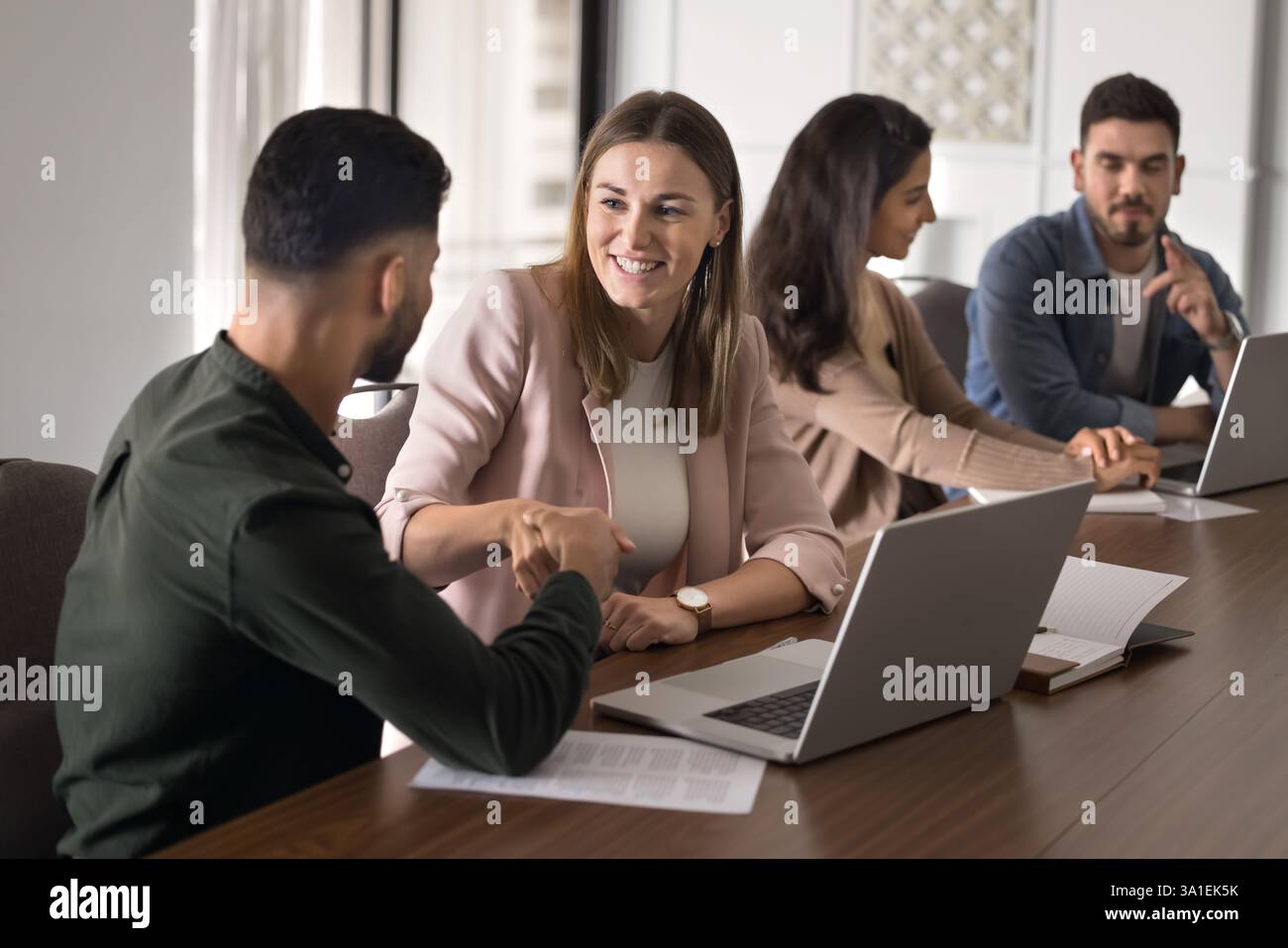 Two teammates greeting each other before teamwork in coworking Stock ...