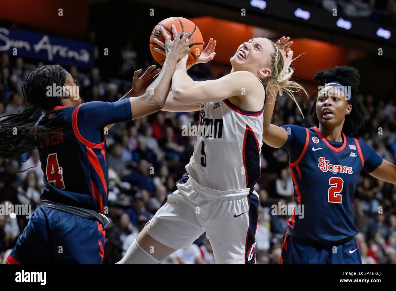 UConn guard Paige Bueckers, center, is fouled by St. John's guard Skye ...