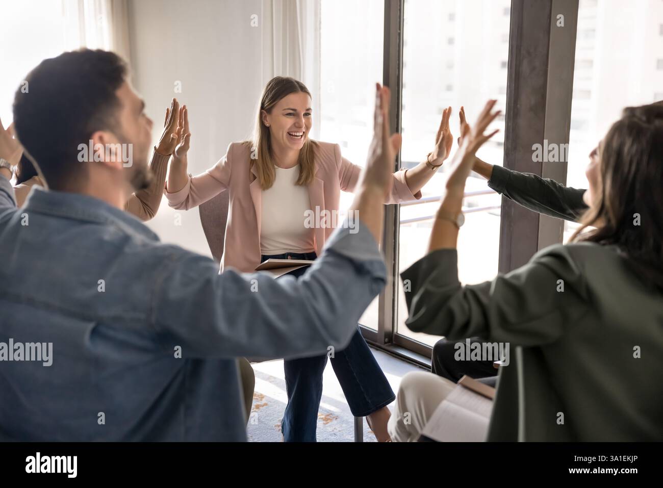 Group of teammates gather in circle giving celebratory high-five ...