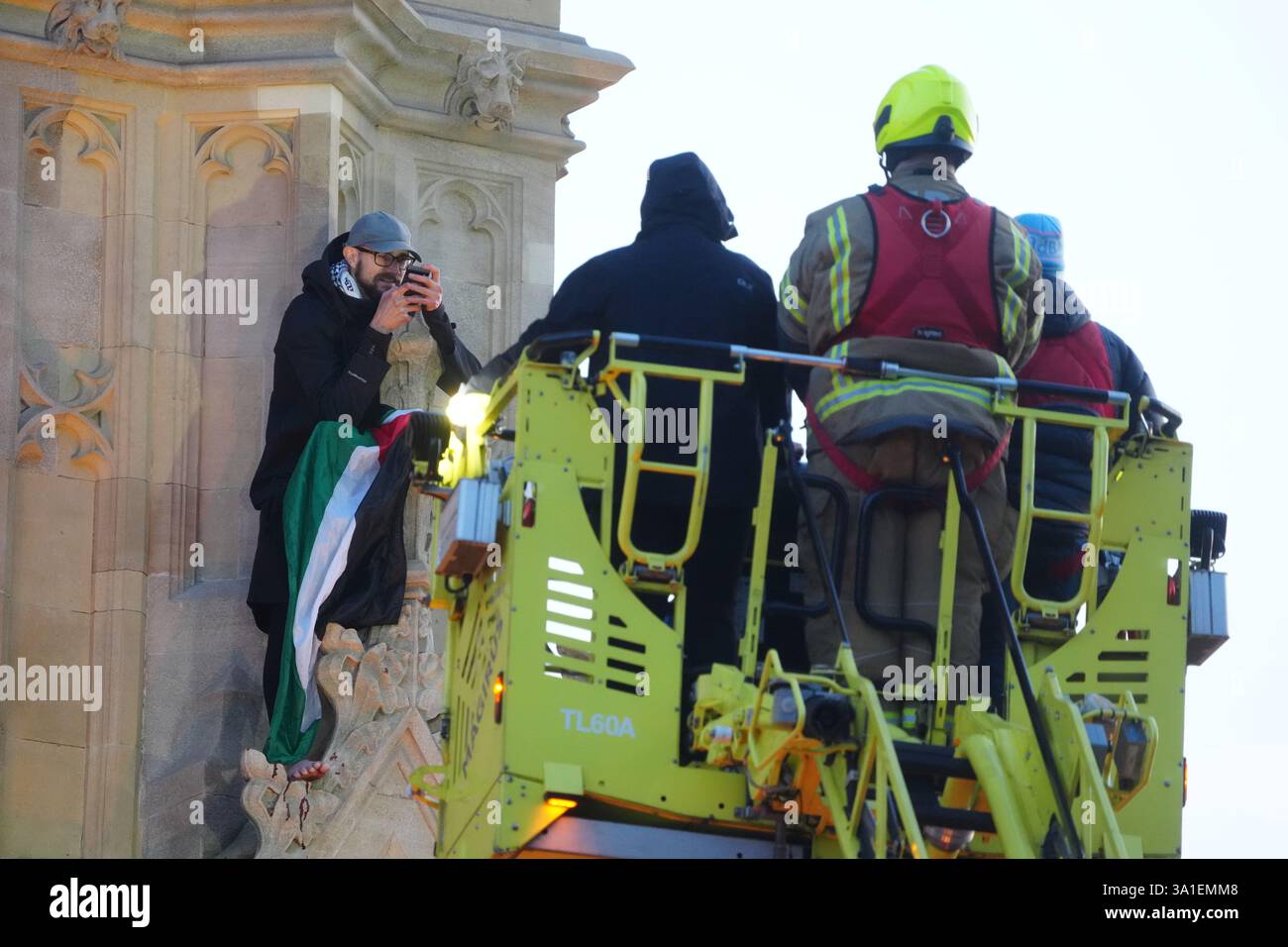 Emergency services talk to a man after he climbed up Elizabeth Tower at ...