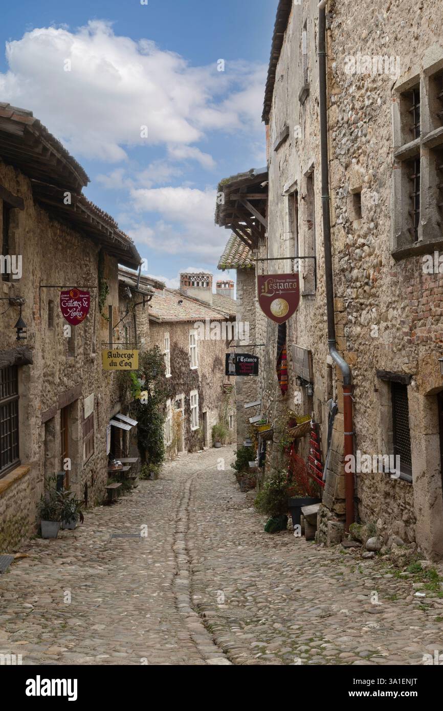 The cobblestoned rue des Rondes in Pérouges, a medieval walled village ...