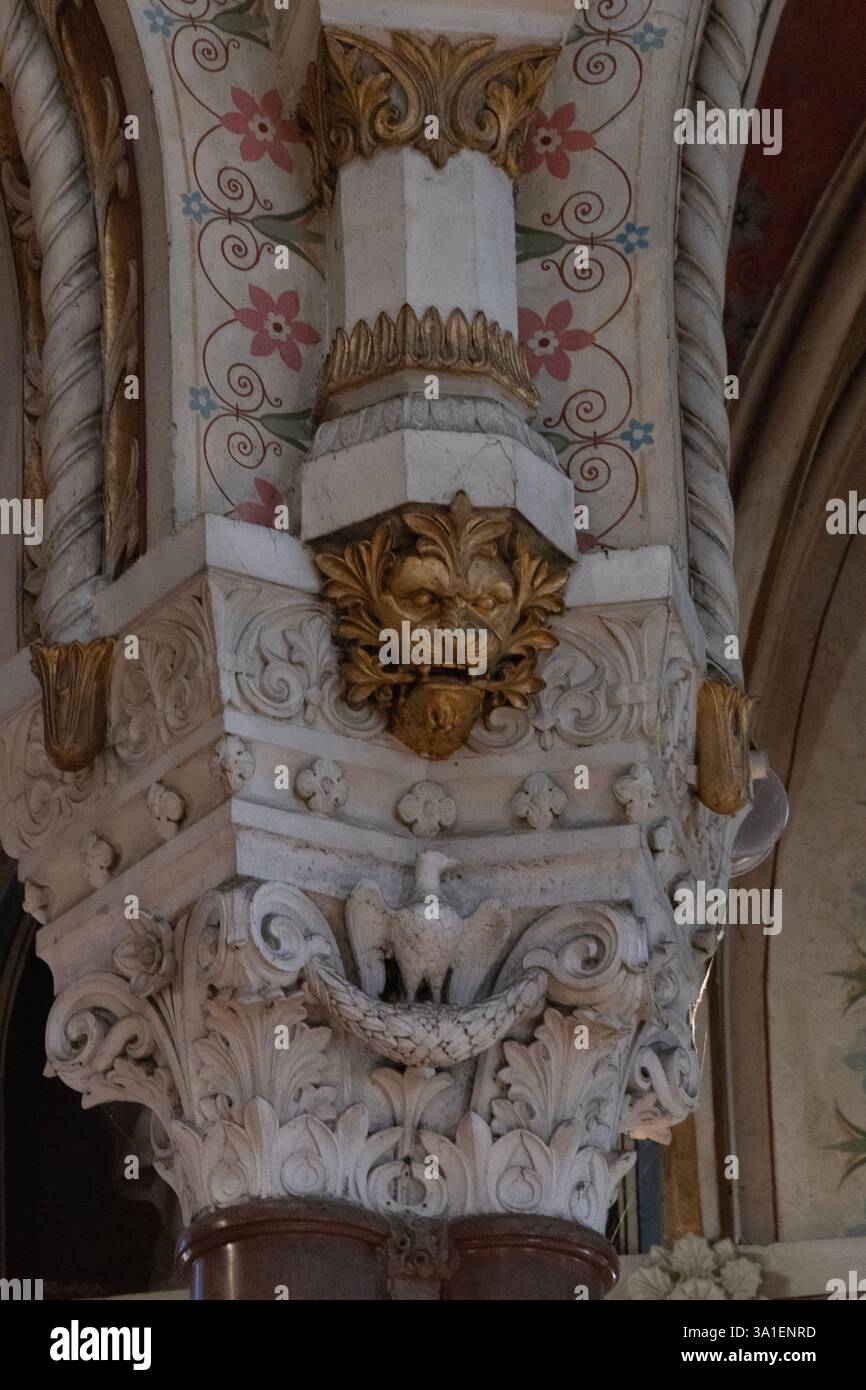 Detail of a pillar with a gold lion's head and hot-wax painted ...