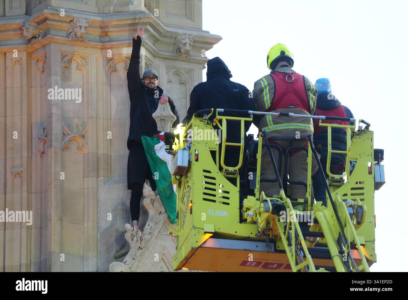 Emergency services talk to a man after he climbed up Elizabeth Tower at ...