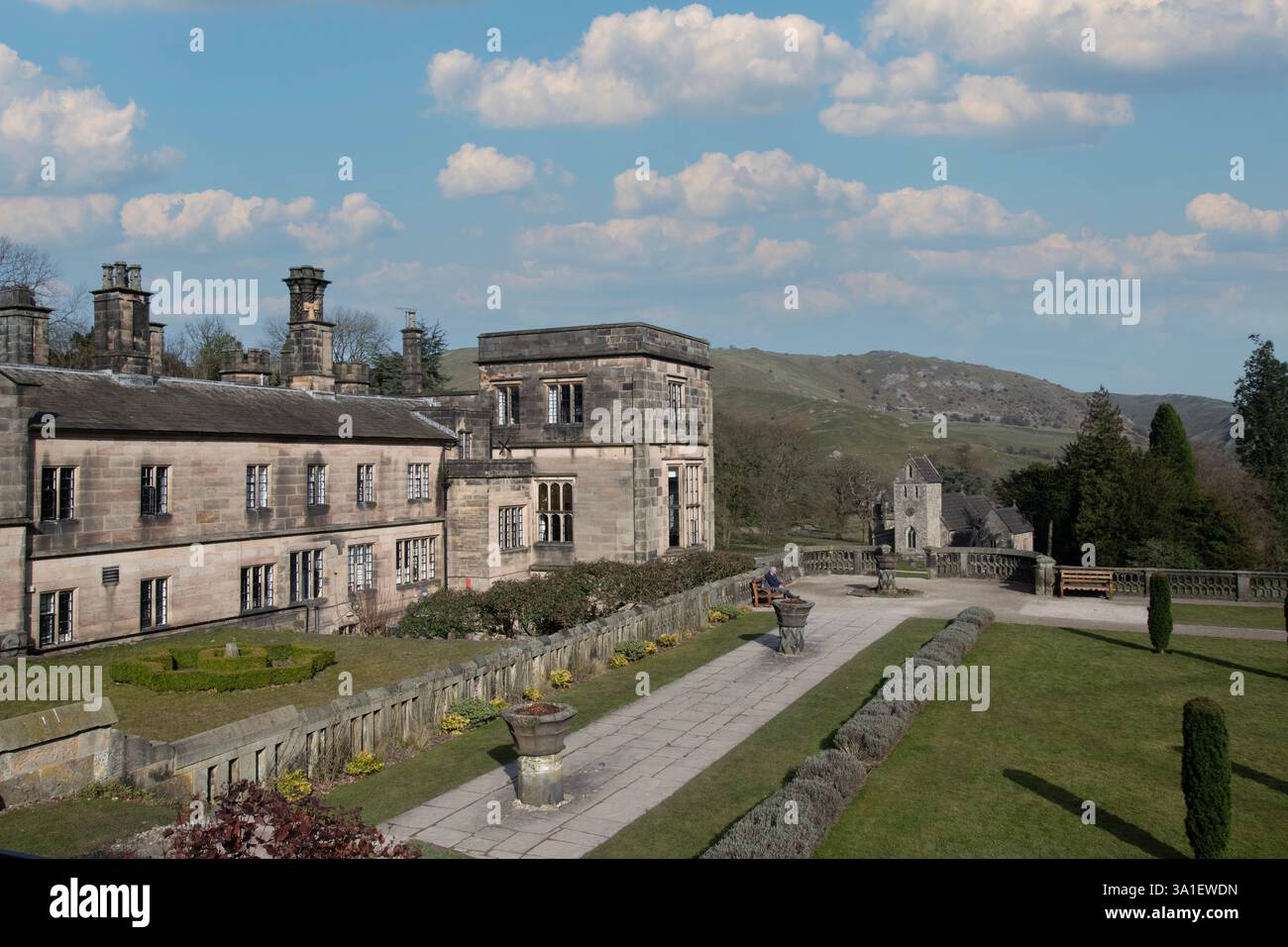 Ilam Hall and gardens looking toward Ilam Church and Thorpe Cloud in the Peak District Stock ...