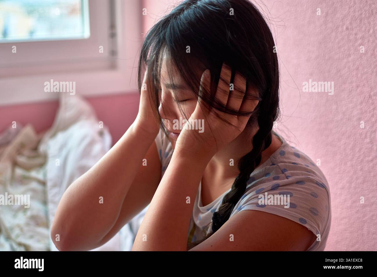 A young Chinese woman with autism in a moment of introspection, gazing ...