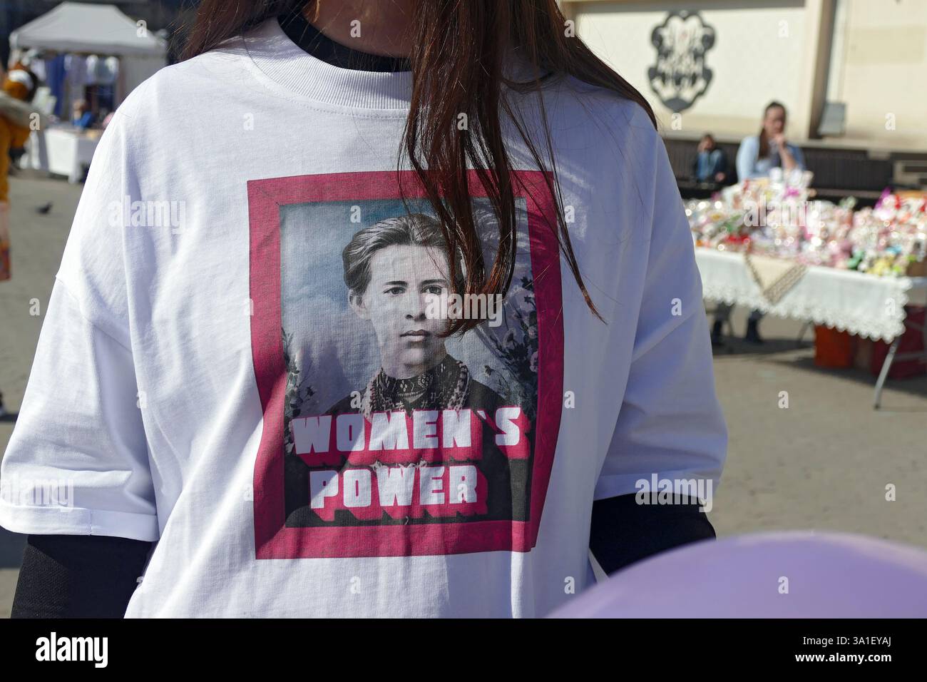 Non Exclusive: A woman wears a T-shirt featuring the portrait of ...