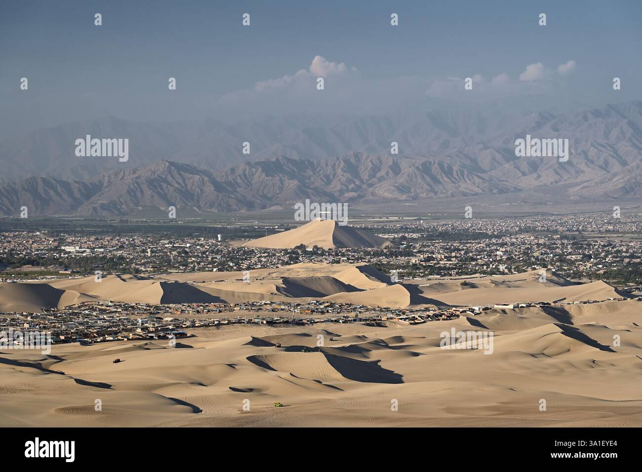 Sand dunes in the Ica desert, with Ica city and the mountains in the ...