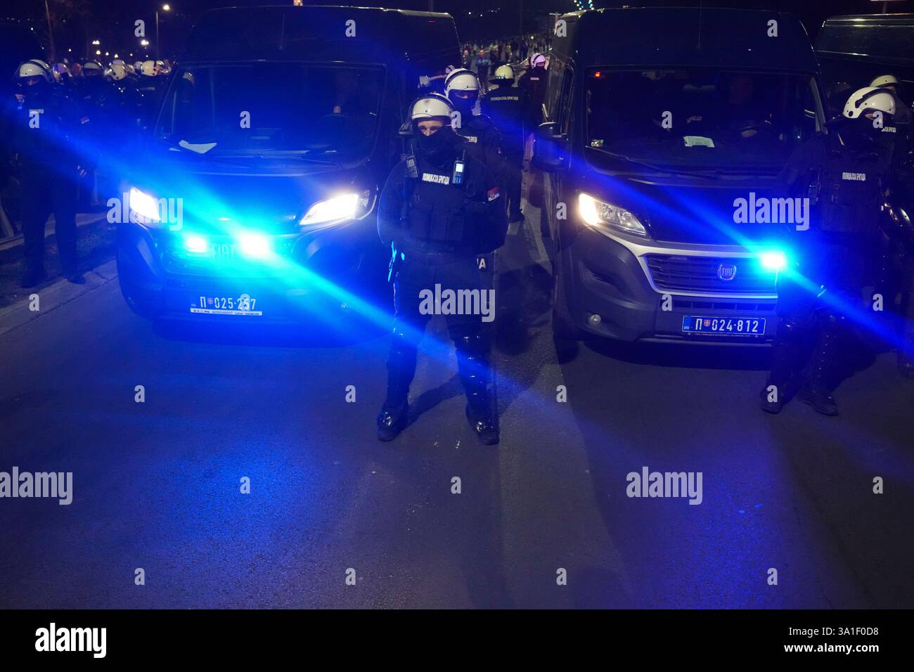 Serbian police officers block a bridge as students and citizens march ...