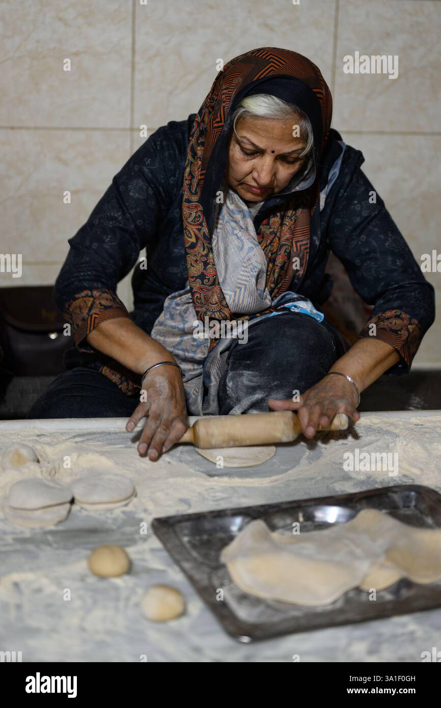 Delhi, India - February 21 2025: Woman Making Bread at a Langar ...
