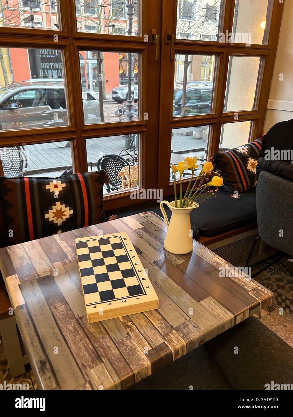 A wooden chess board on the table at the restaurant, playing brain game ...