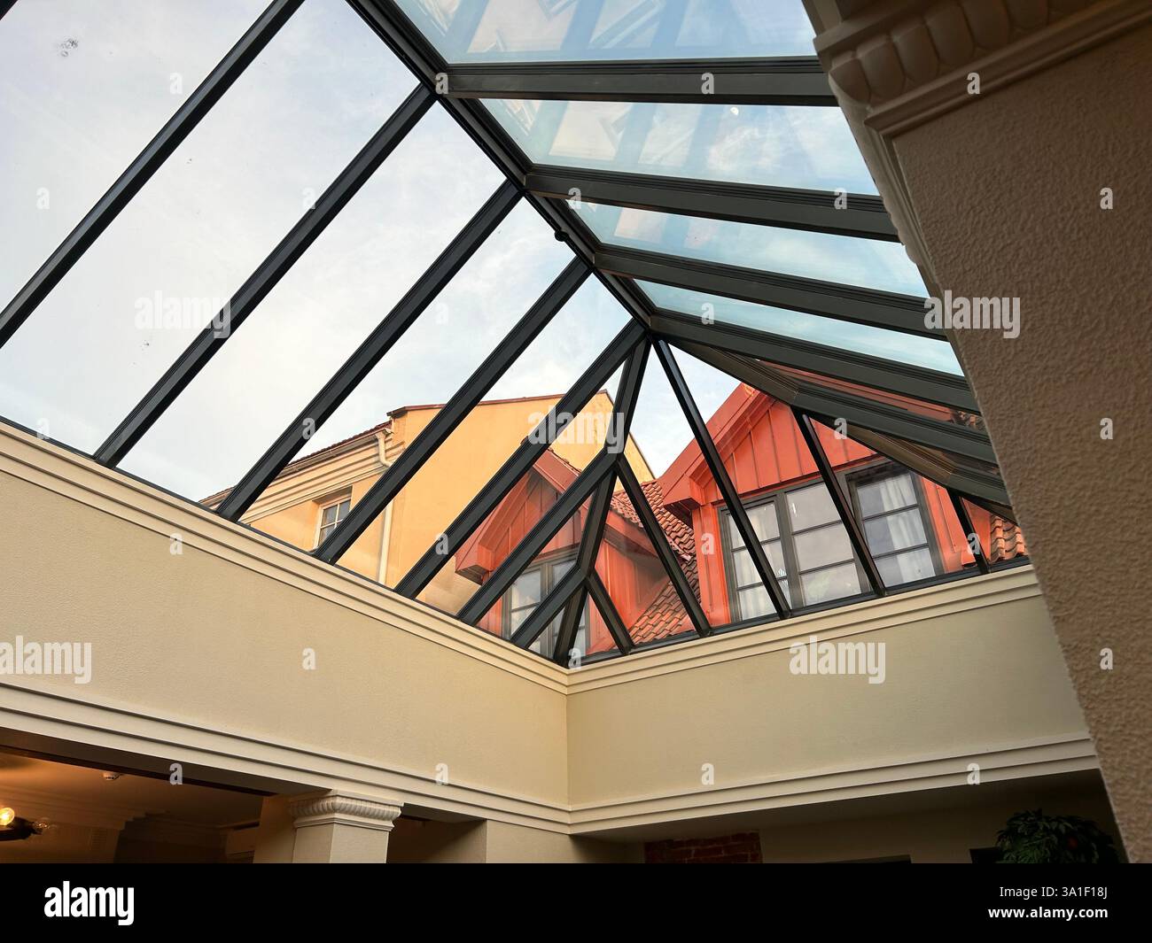 A glass clear ceiling in the food restaurant, blue cloudy sky, two ...