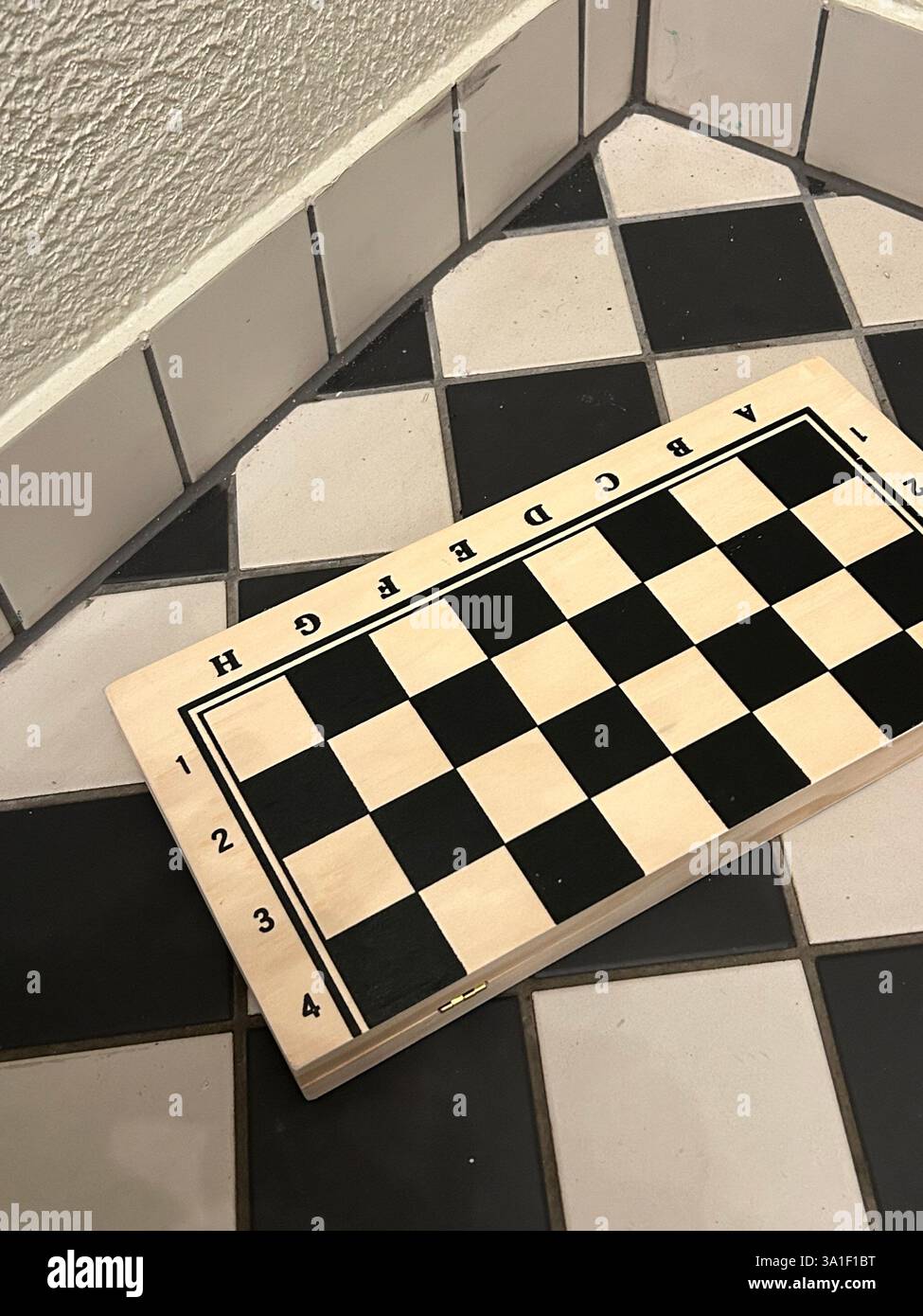 wooden chess board with game pieces on the textured black and white ...