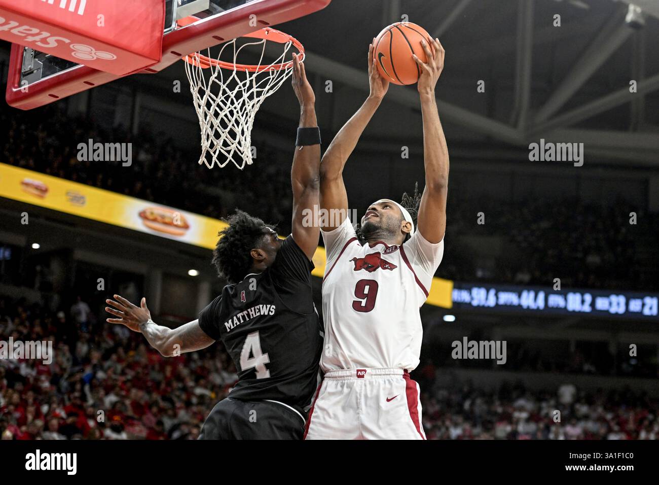 Arkansas forward Jonas Aidoo (9) shoots over Mississippi State forward Cameron Matthews (4 ...