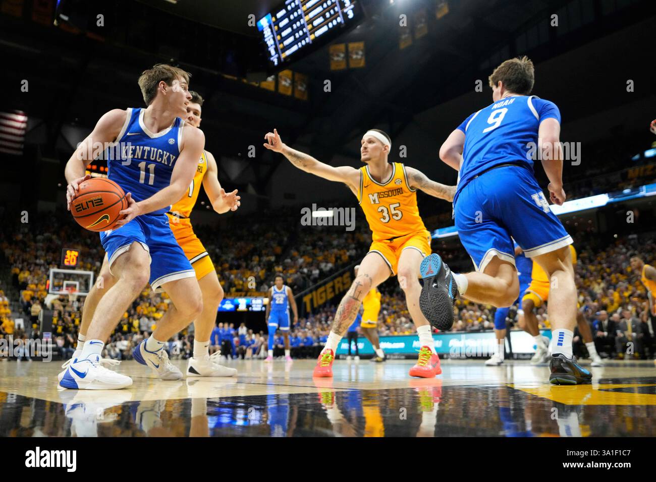Kentucky's Travis Perry (11) looks to pass as Missouri's Jacob Crews ...
