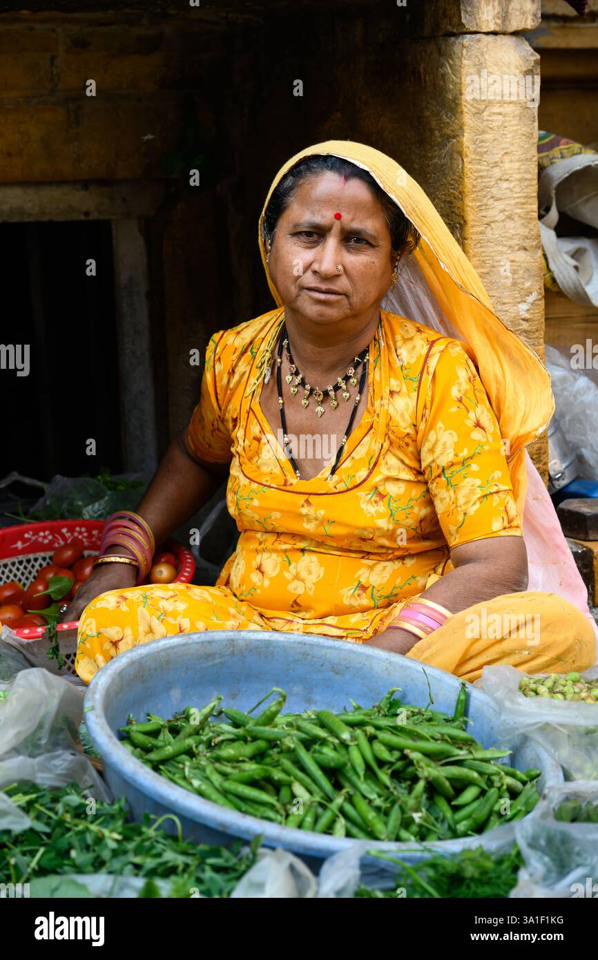 Jaisalmer, Rajasthan, India - February 12 2025: Woman in Traditional Yellow Dress Selling ...