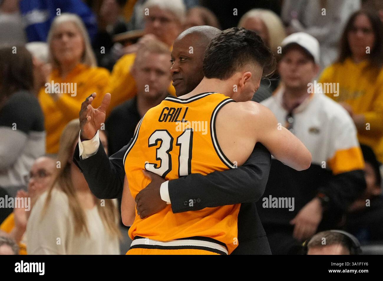Missouri's Caleb Grill (31) hugs head coach Dennis Gates as Grill ...