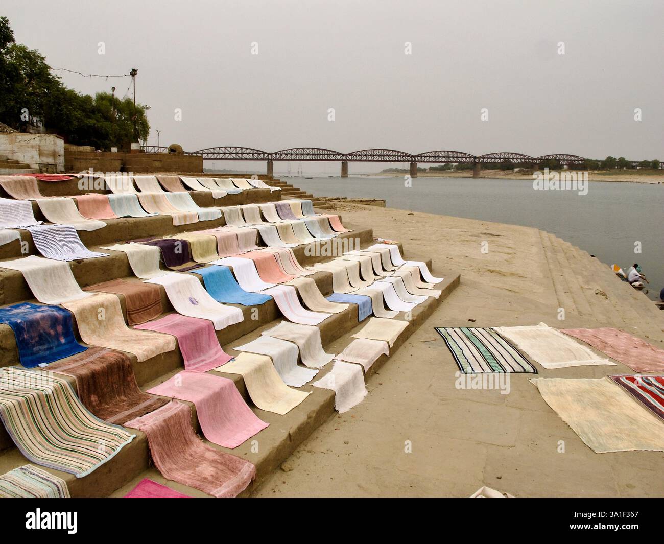 Laundry dries on the steps of Raj Ghat in Varanasi, with Malviya Bridge ...