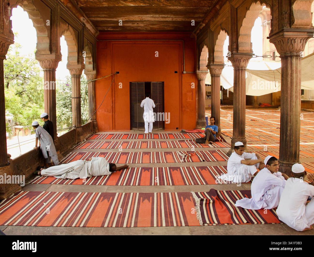 People rest and seek shelter from the heat in the shaded pillared ...