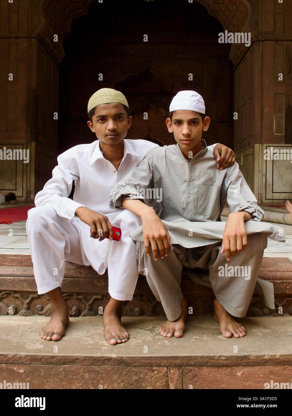 Two madrasa students pose for a portrait on the steps of Jama Masjid ...