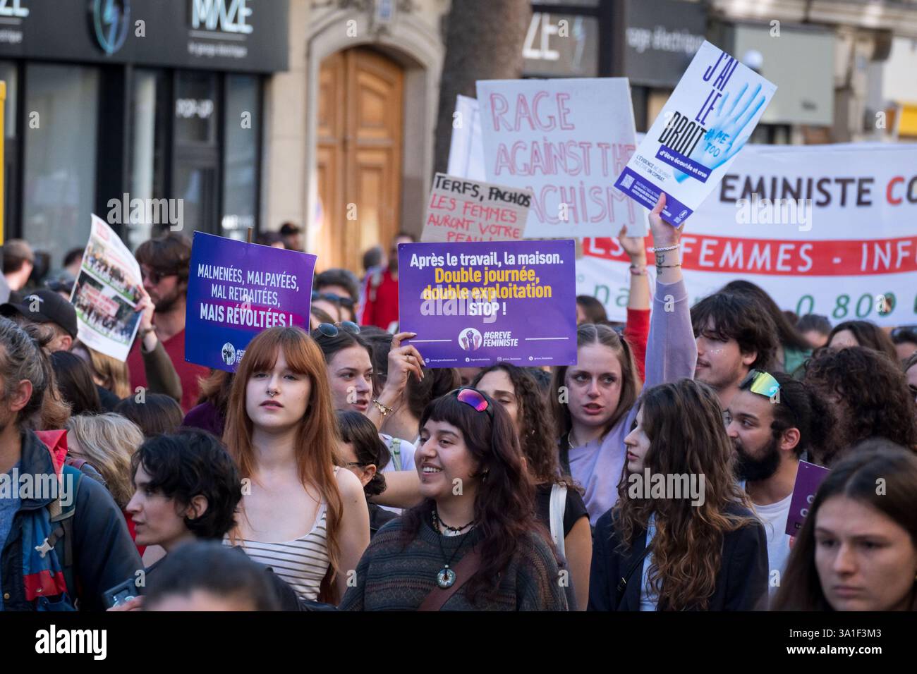 Paris, France. 8th Mar 2025. Young feminist demonstrators with signs ...