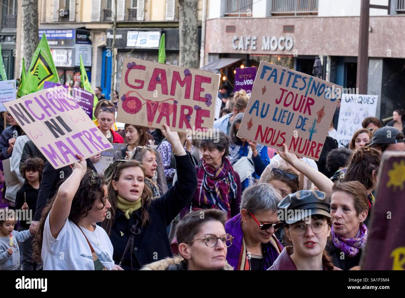 Feminist demonstrators march with signs advocating for women's rights ...