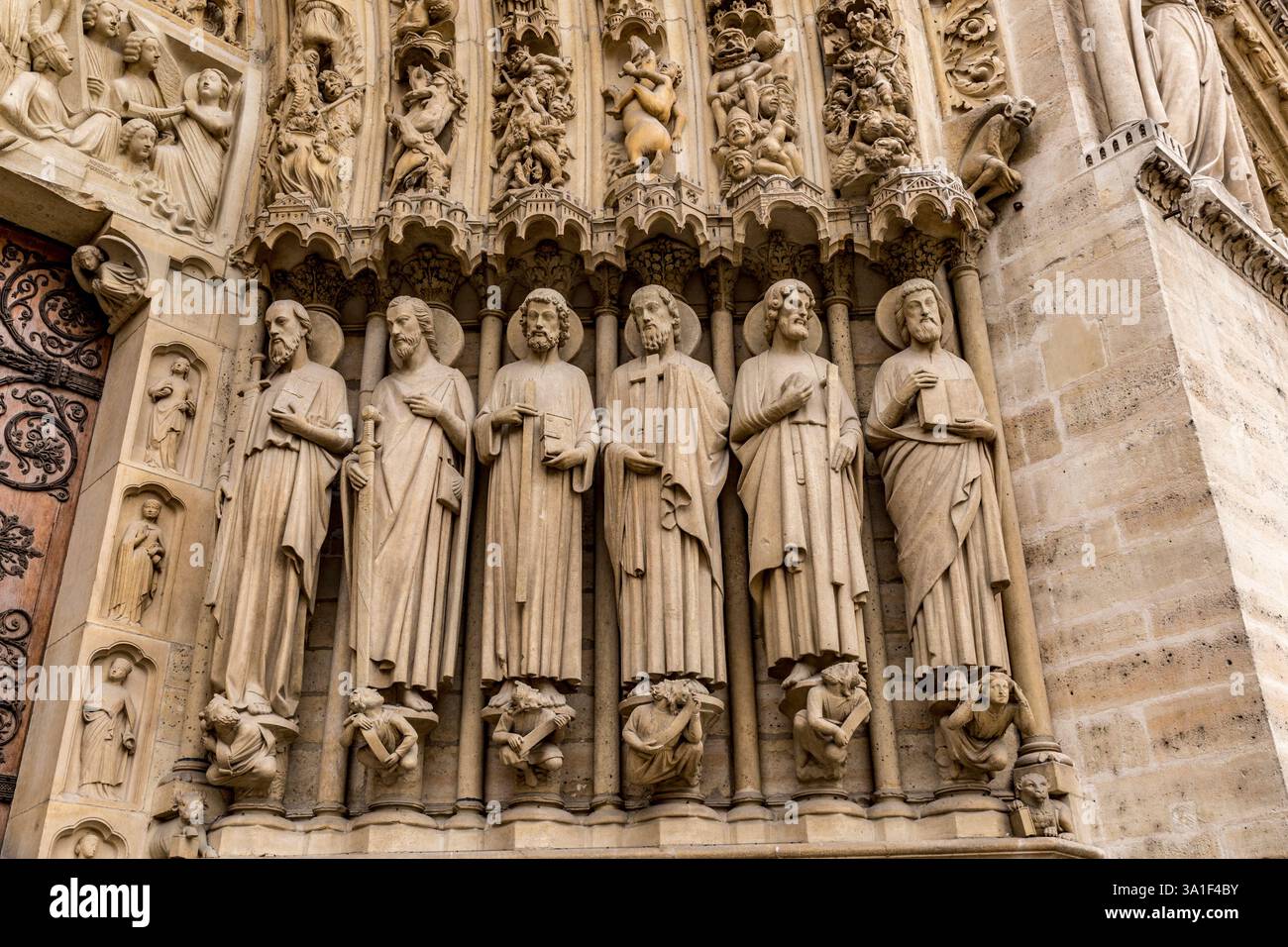 Europe, France, Paris. Front facade of Notra Dame. Statues of saints ...