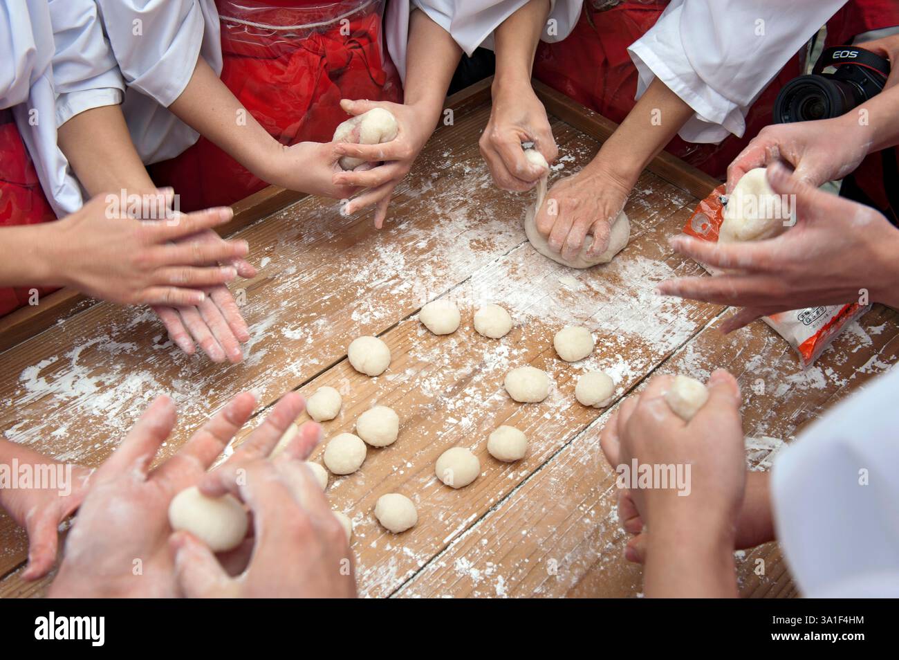Mochitsuki, miko shrine maidens making traditional Japanese rice cakes ...
