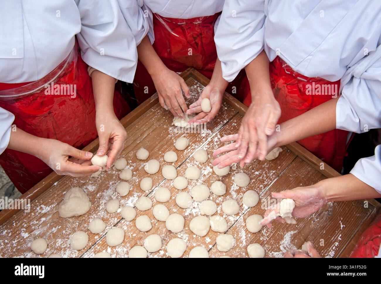 Mochitsuki, miko shrine maidens making traditional Japanese rice cakes ...