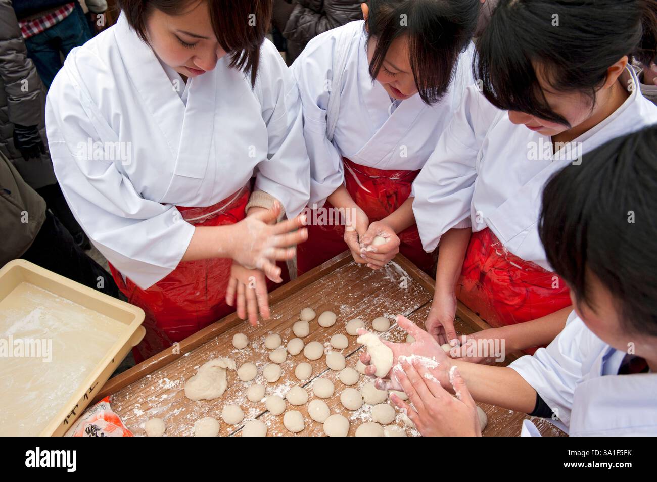 Mochitsuki, miko shrine maidens making traditional Japanese rice cakes ...