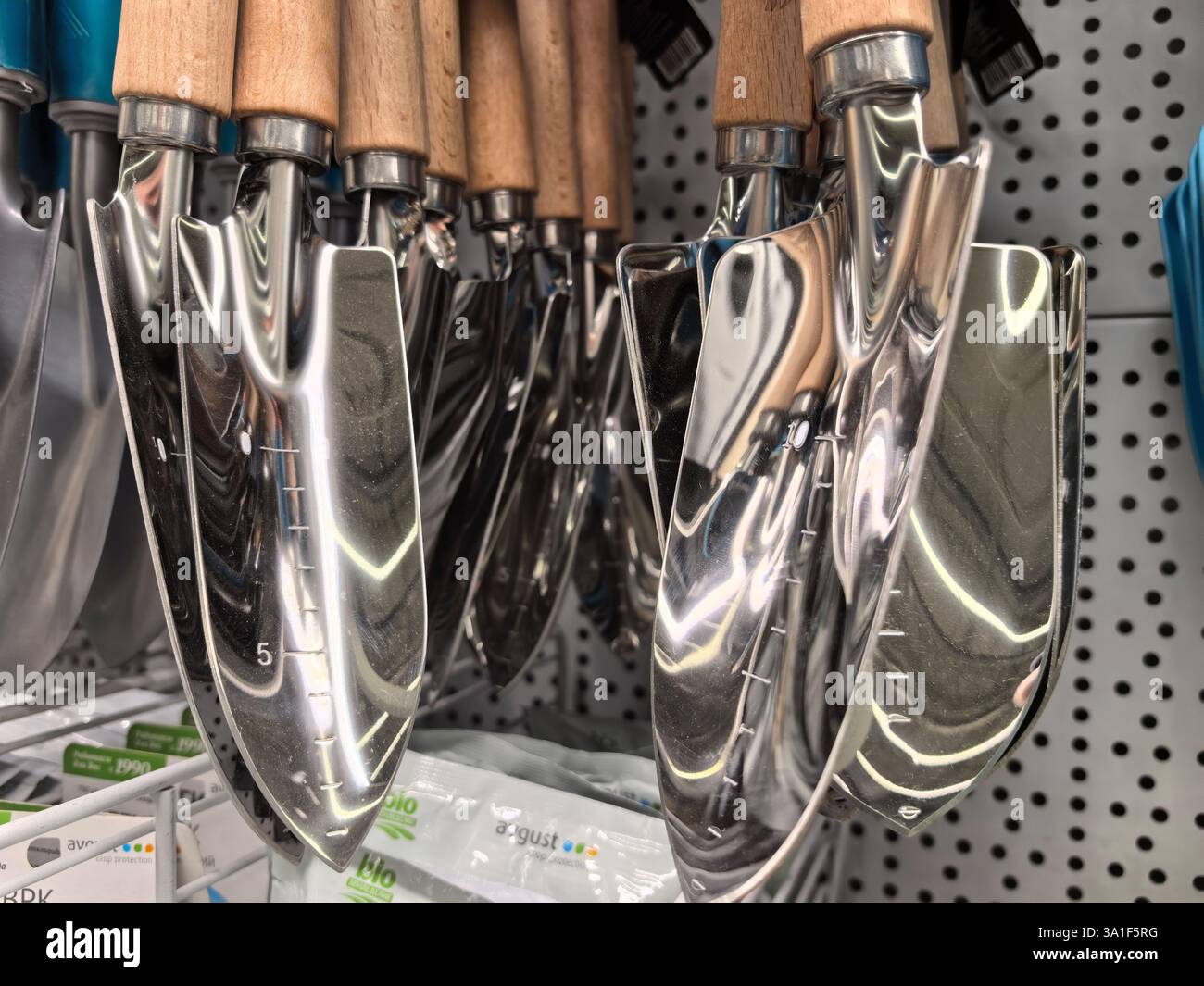 Bobruisk, Belarus - February 22, 2025: Shiny metal garden trowels with ...